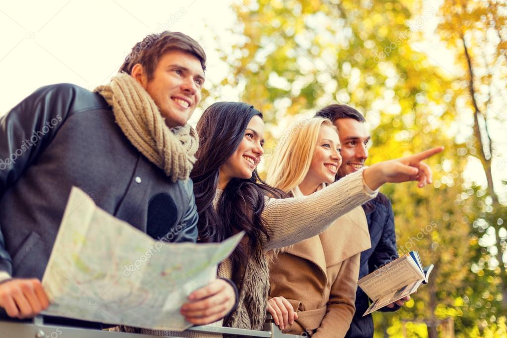 Group of friends with map outdoors — Stock Photo © Syda_Productions ...