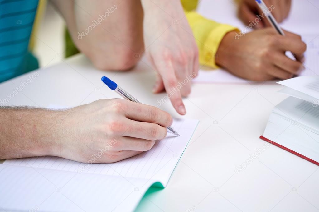 Close up of students hands writing to notebooks — Stock Photo © Syda ...