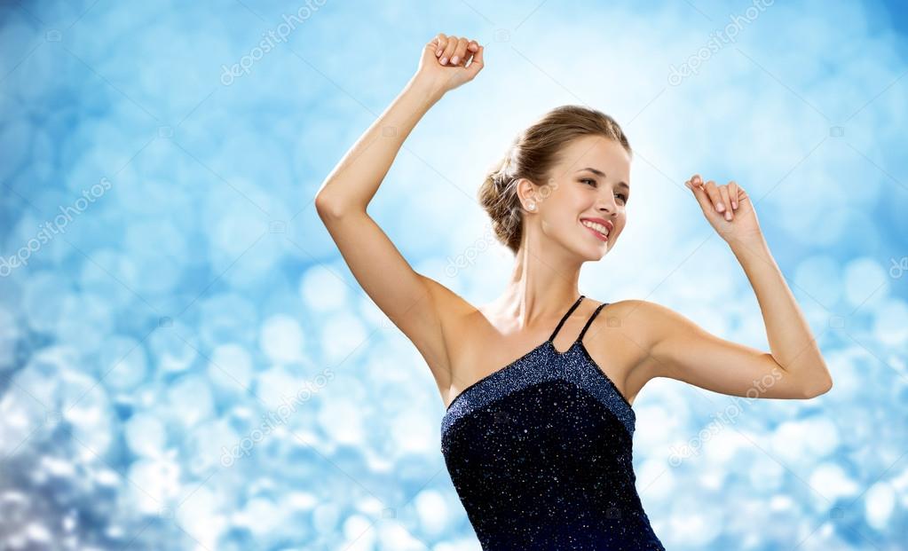 Woman dancing with raised hands Stock Photo by ©Syda_Productions 83122990