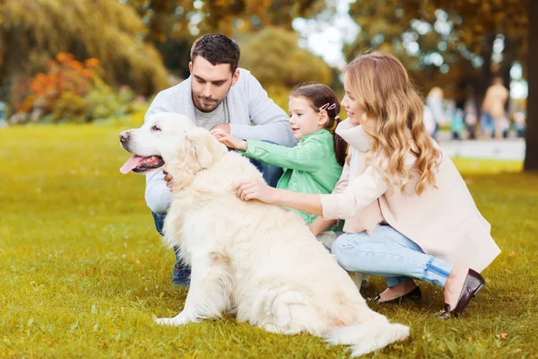 happy family with labrador retriever dog in park - Stock Image - Everypixel