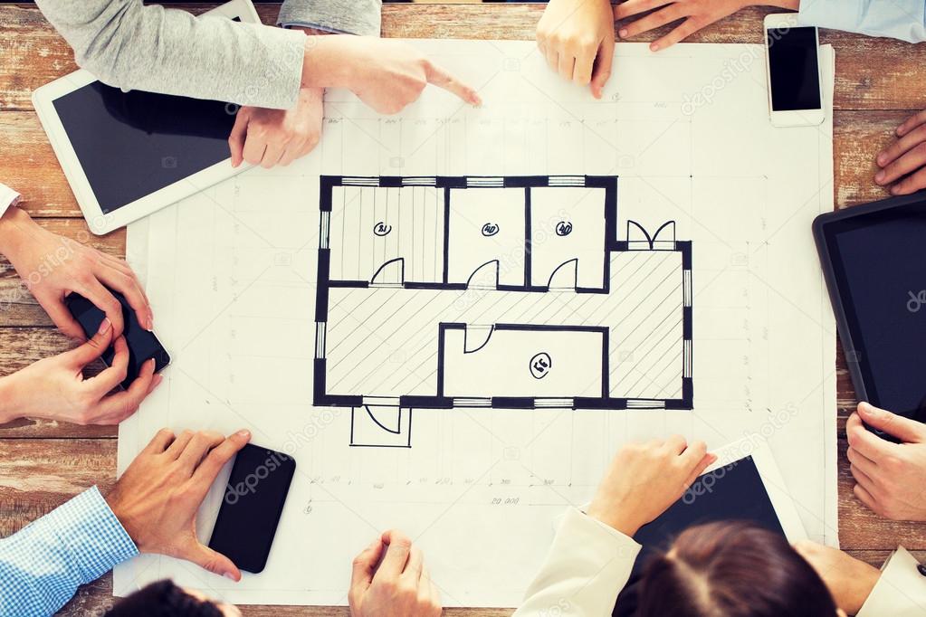 Business team with blueprint and gadgets — Stock Photo © Syda ...