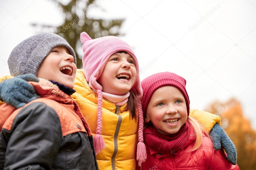 Group of happy children hugging in autumn park Stock Photo by ©Syda ...
