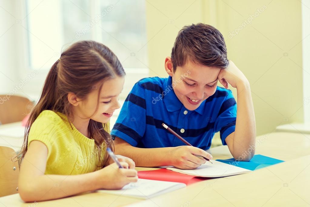 Group of school kids writing test in classroom Stock Photo by ©Syda ...