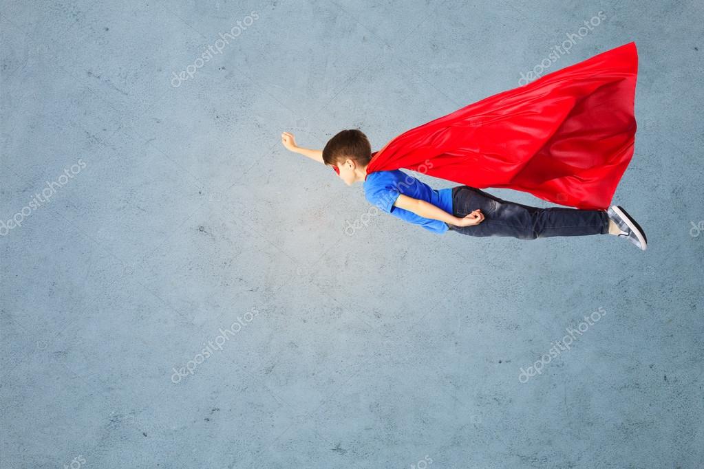 Boy in red superhero cape and mask flying on air Stock Photo by ©Syda ...