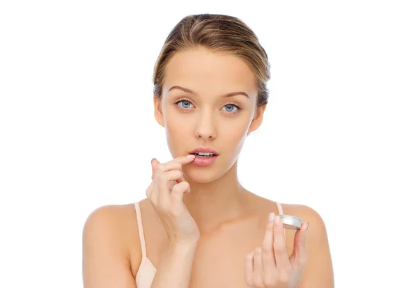 Young woman applying lip balm to her lips Stock Photo by ©Syda ...