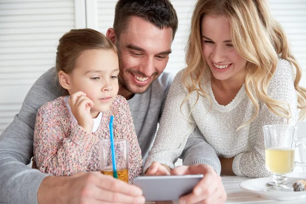 happy family with smartphone at restaurant - Stock Image - Everypixel