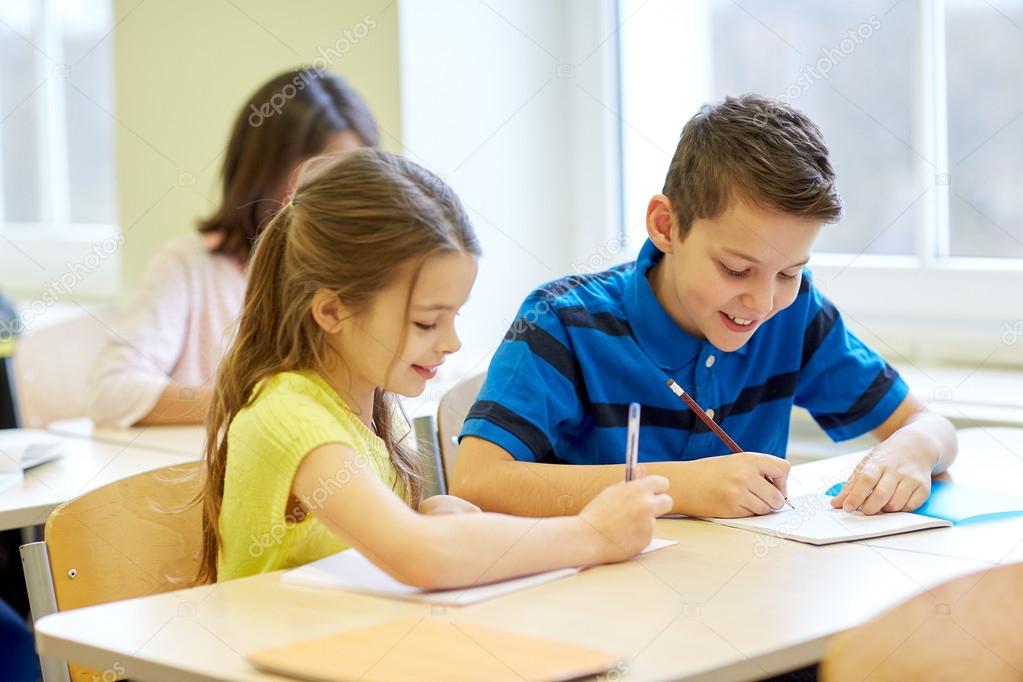 Group of school kids writing test in classroom — Stock Photo © Syda ...