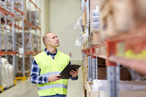 Man with clipboard in safety vest at warehouse Stock Photo by ©Syda ...