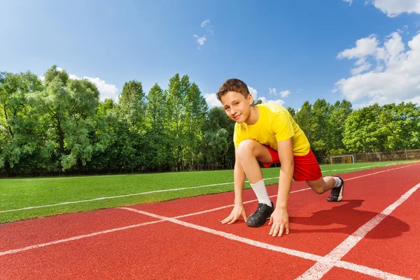 Teenage sprinter crossing finish line — Stock Photo © serrnovik #130010522