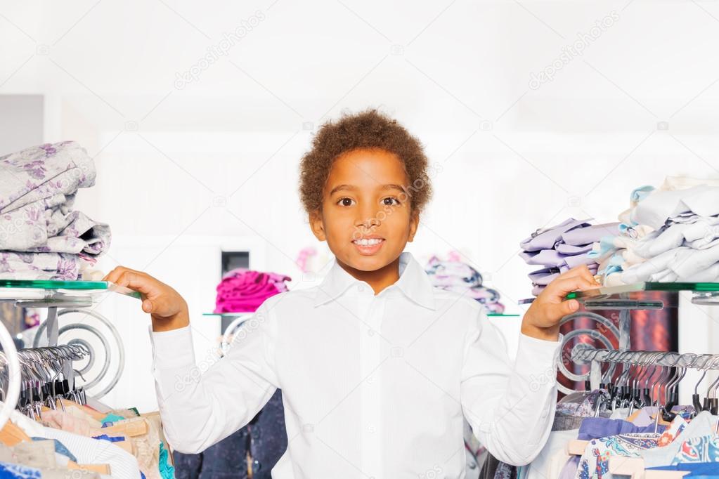 African boy in clothes store Stock Photo by ©serrnovik 65981921