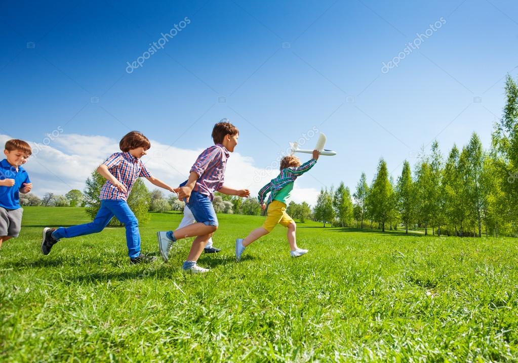 Happy running kids with airplane toy — Stock Photo © serrnovik #77387570