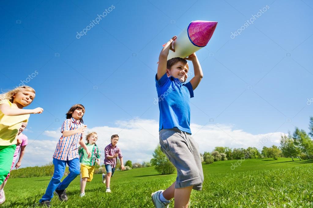 Boy with rocket toy and children running — Stock Photo © serrnovik ...