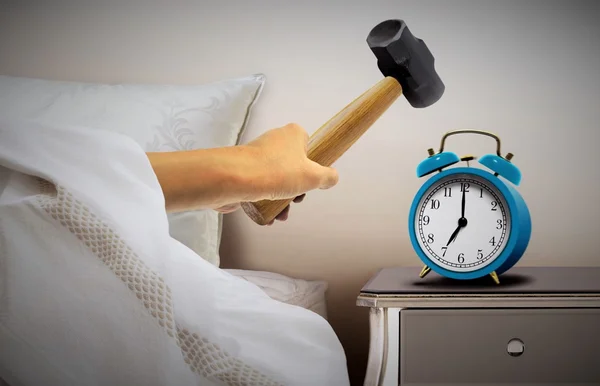 Hand hitting alarm clock with hammer Stock Photo by ©razihusin 124361786