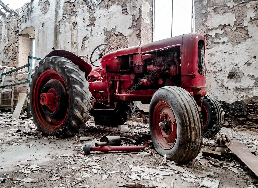 Old, broken tractor indoors Stock Photo by ©amoklv 83110286