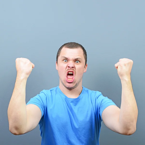 Portrait of ecstatic young man celebrating victory or win agains Stock ...