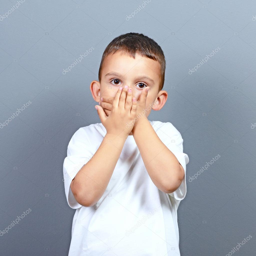 Cute little boy kid covering his face with hands against gray ba Stock ...