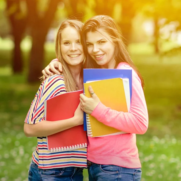 Happy students in summer park - Stock Image - Everypixel
