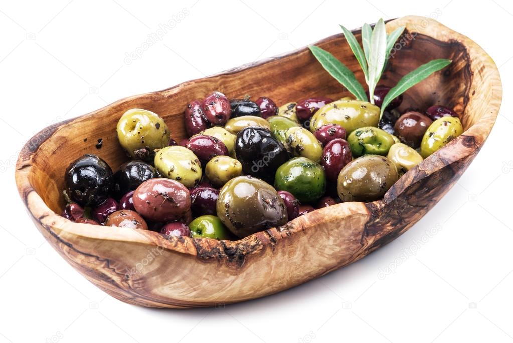 Whole table olives in the wooden bowl on the white background. Stock ...