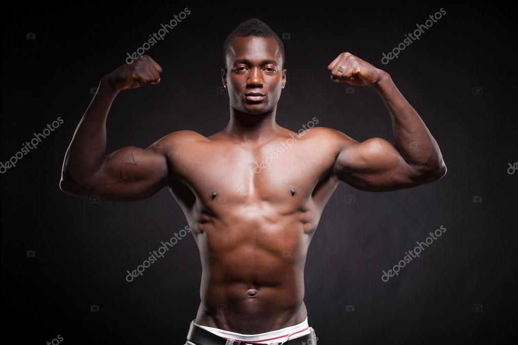 Beautiful and muscular black man in dark background Stock Photo by ...