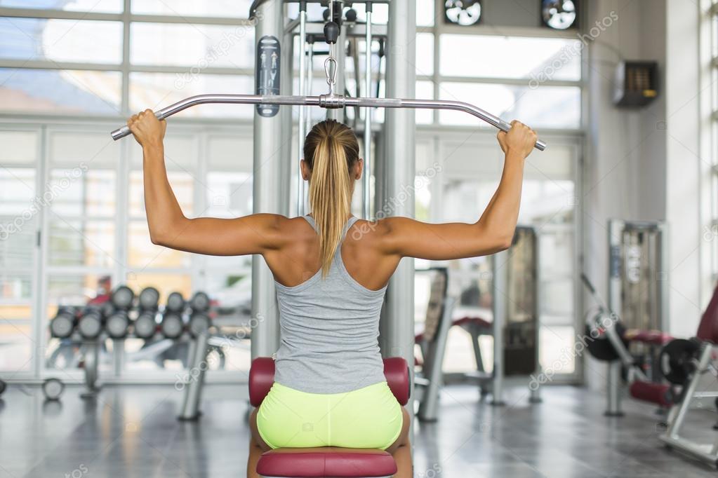 Pretty young woman training in the gym Stock Photo by ©boggy22 61903611