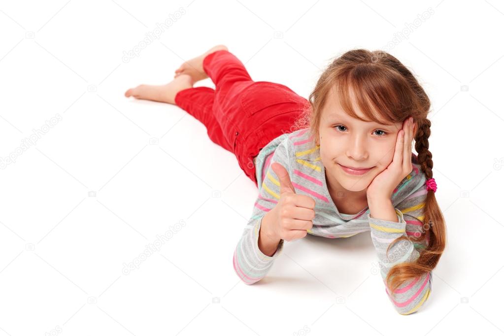 Front view of smiling child girl lying on stomach — Stock Photo © pavel ...