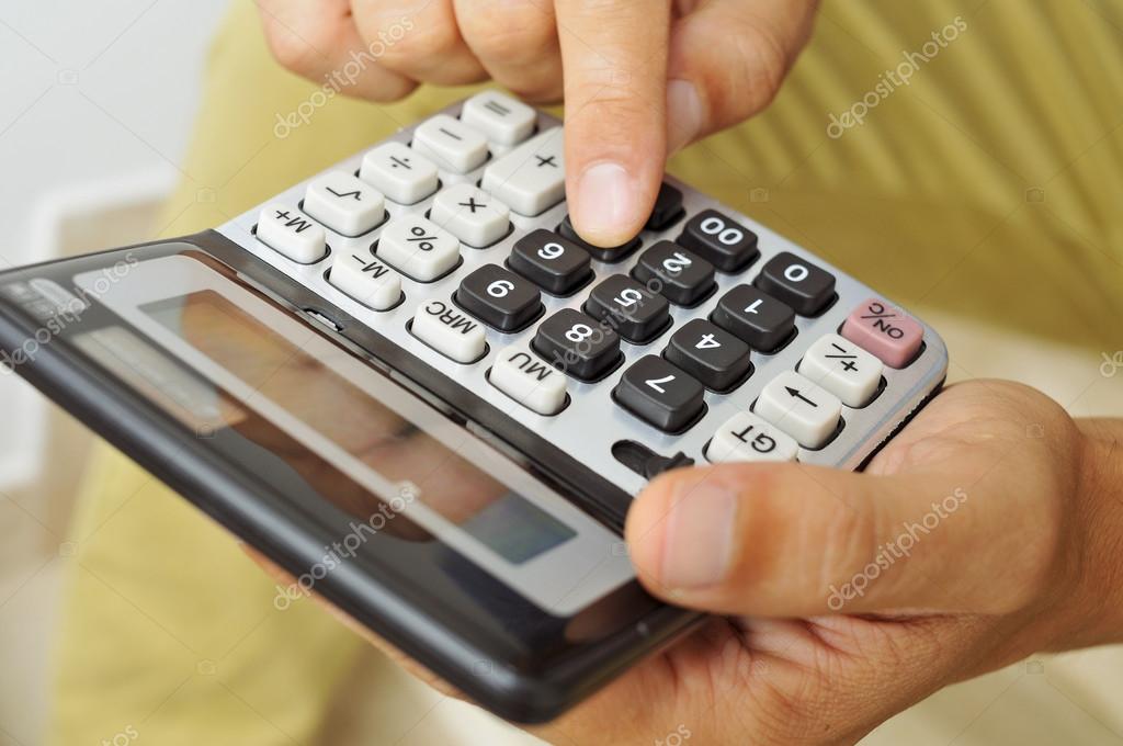 Young man using a calculator — Stock Photo © nito103 #57404225