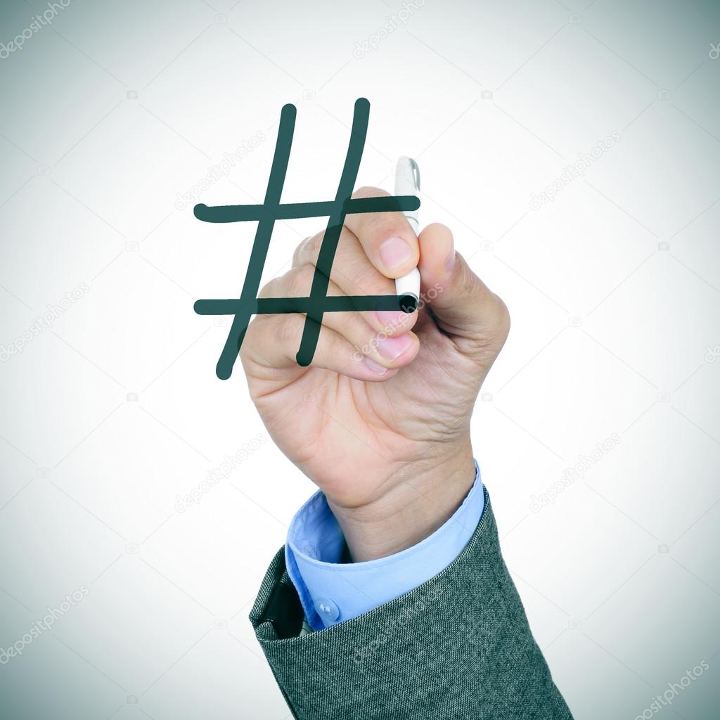 Businessman handwriting a hash sign, vignetted — Stock Photo © nito103 ...