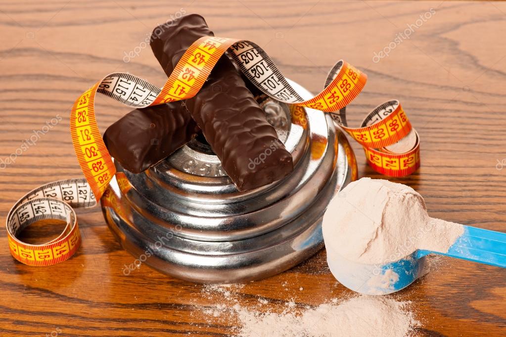 Whey protein powder in measuring scoop, protein bar, meter tape Stock ...