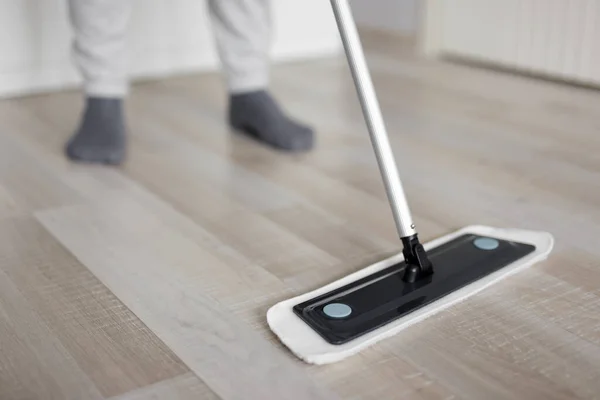 close up of man washing floor with mop at home - Stock Image - Everypixel