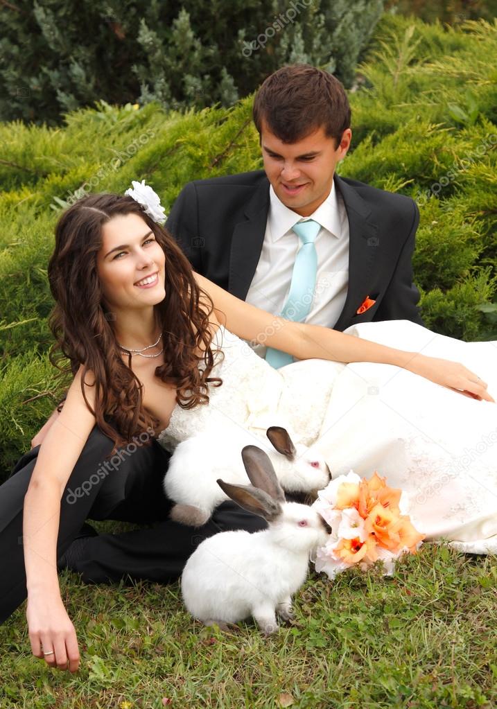Bride with groom with two rabbits — Stock Photo © khorzhevska #81223002