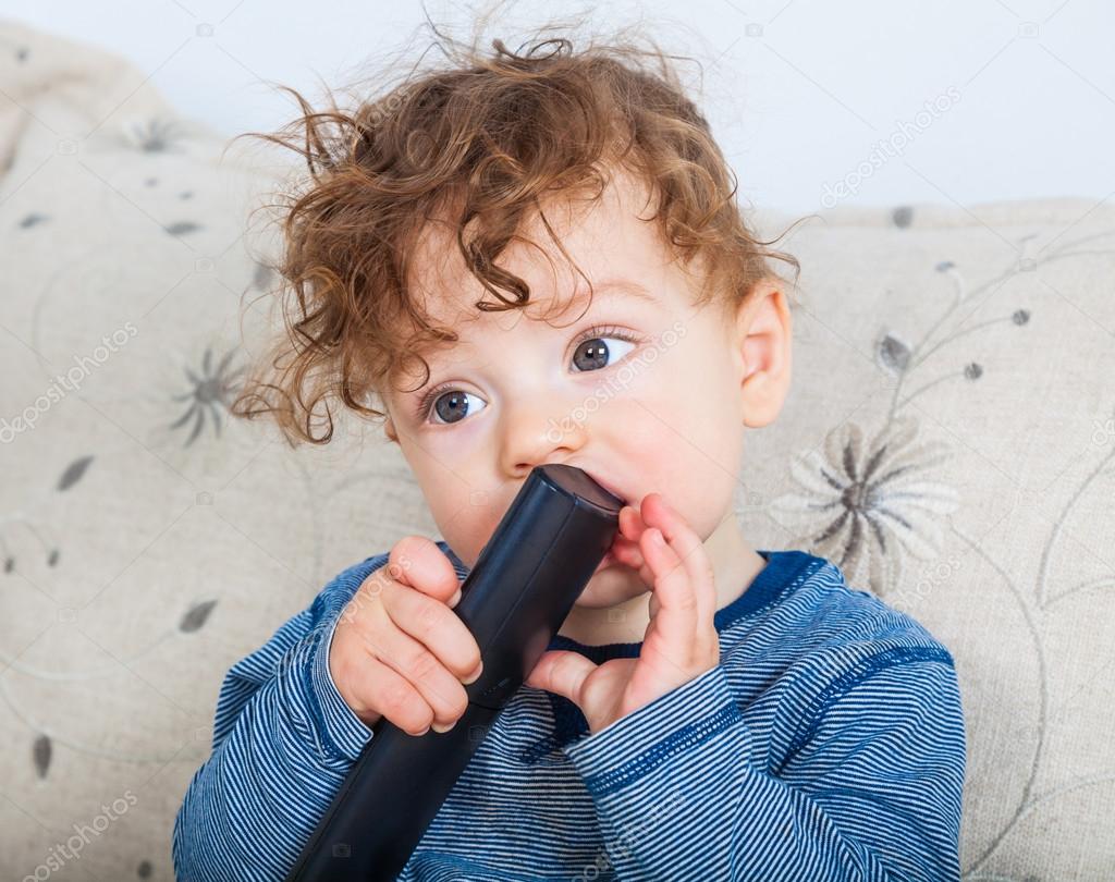 Baby boy with remote — Stock Photo © igabriela #82474488