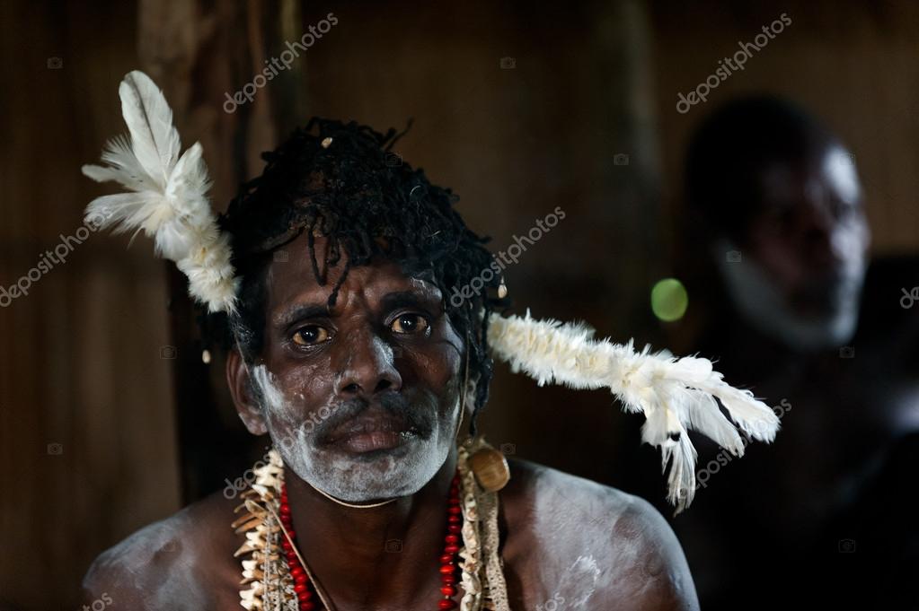 The Portrait Asmat warrior with a traditional painting and coloring on ...