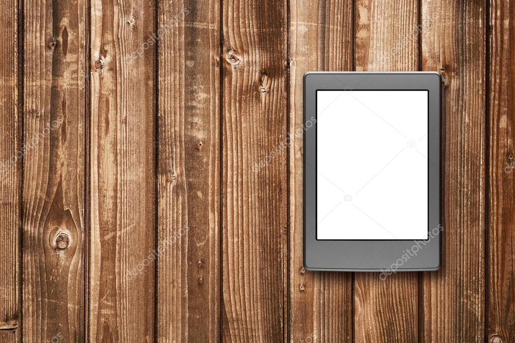 E-book reader on wooden background Stock Photo by ©windujedi 110314176