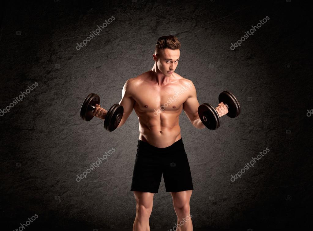 Sexy weight lifter guy showing muscles Stock Photo by ©ra2studio 103642780