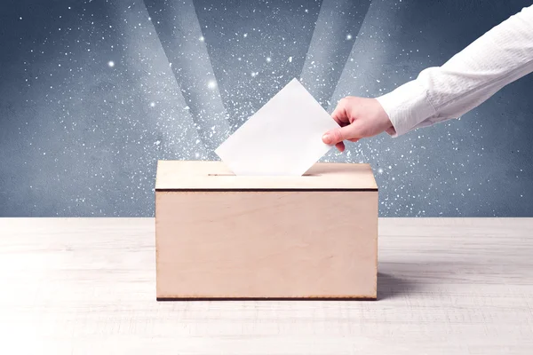 Ballot box with person casting vote Stock Photo by ©ra2studio 182463524
