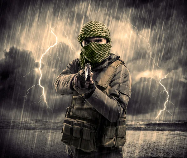 Dangerous armed terrorist with mask and gun in a thunderstorm wi Stock ...