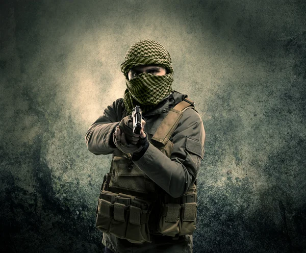Portrait of a heavily armed masked soldier with grungy backgroun Stock ...