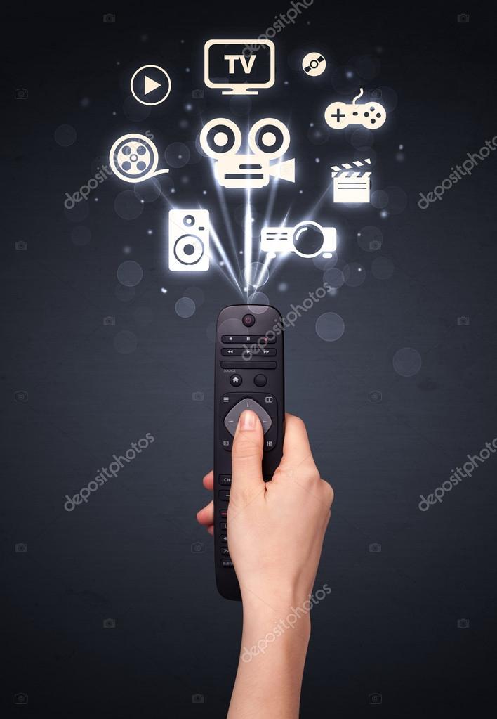 Hand with remote control and media icons — Stock Photo © ra2studio ...