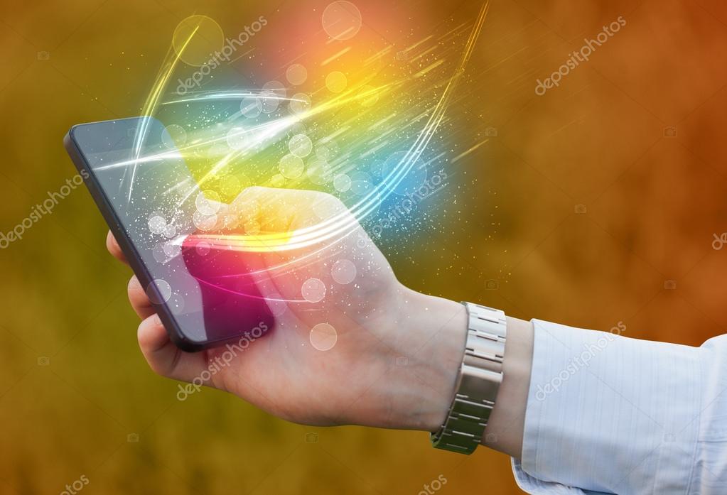 Hand holding smart phone with abstract glowing lines — Stock Photo ...