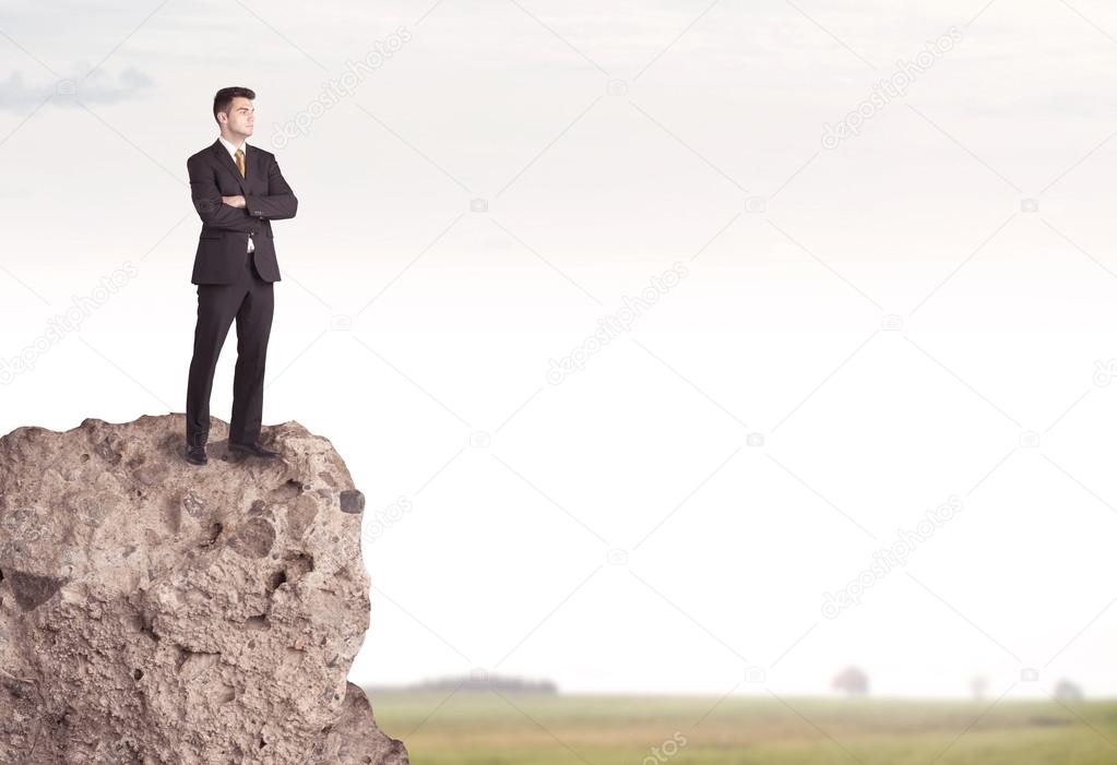 Happy salesman on cliff in the country — Stock Photo © ra2studio #119964238