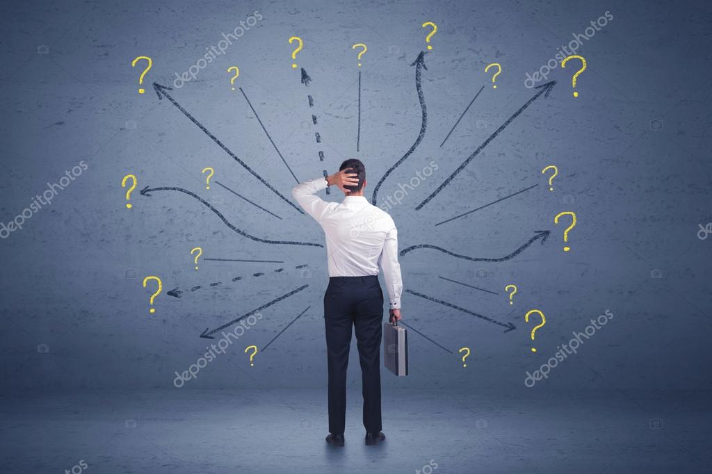 Businessman standing in front lines and question mark signs conc Stock ...