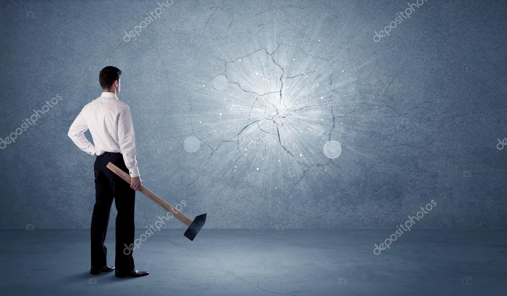 Business man hitting wall with a hammer Stock Photo by ©ra2studio 121729284