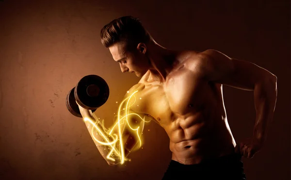 Muscular body builder lifting weight with energy lights on bicep Stock ...