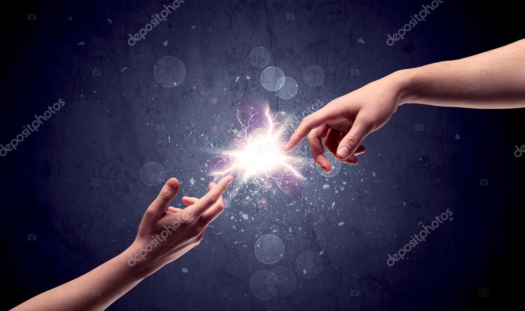 Hands reaching to light a spark Stock Photo by ©ra2studio 124115538