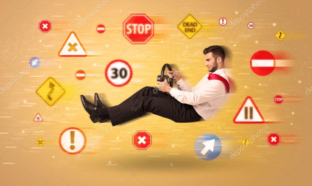 Young driver with road signs around him — Stock Photo © ra2studio #63481155