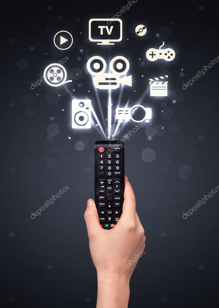 Hand with remote control and media icons — Stock Photo © ra2studio ...