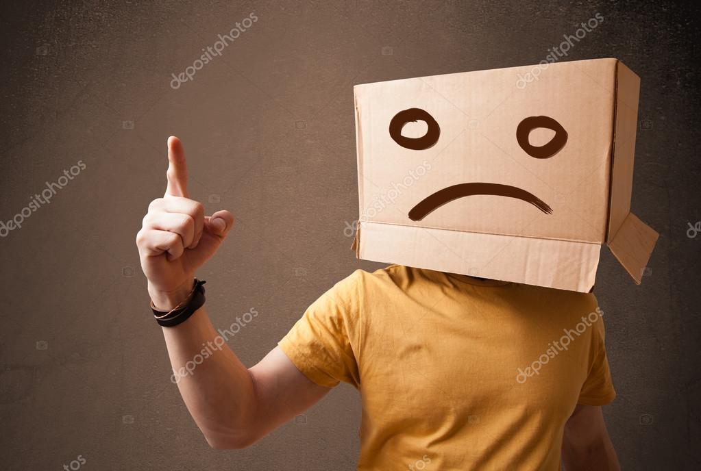 Young man with a brown cardboard box on his head with sad face — Stock ...