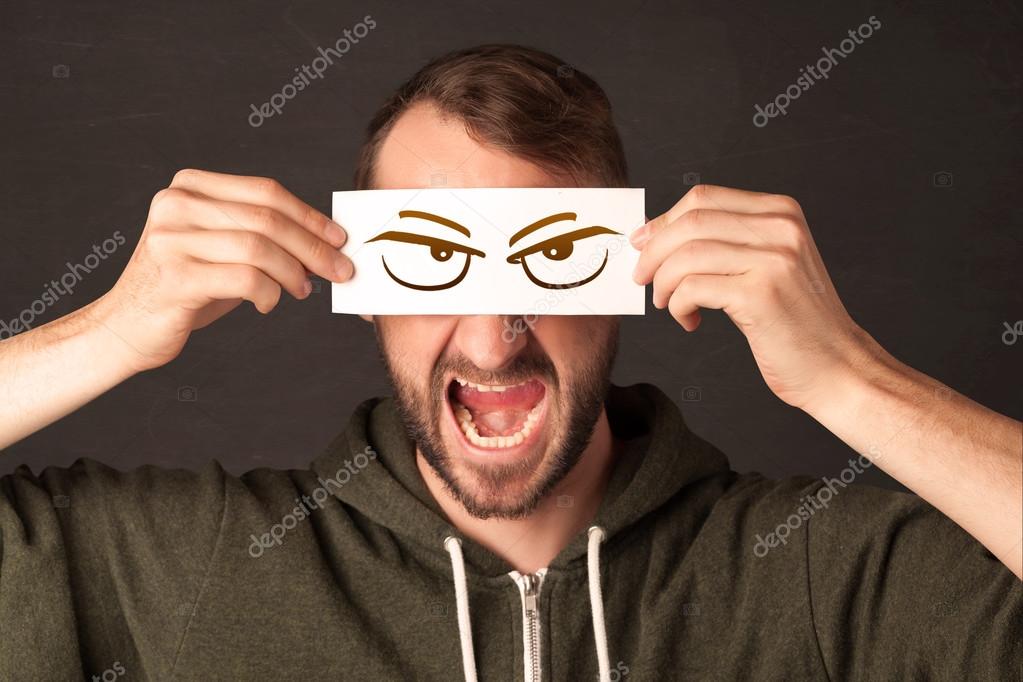 Young person holding paper with angry eye drawing — Stock Photo ...
