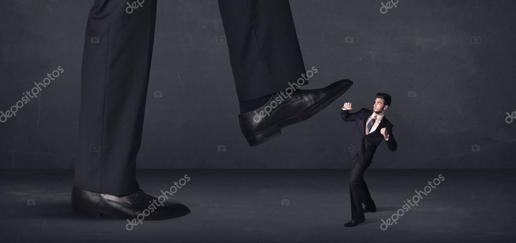 Giant person stepping on a little businessman concept — Stock Photo ...