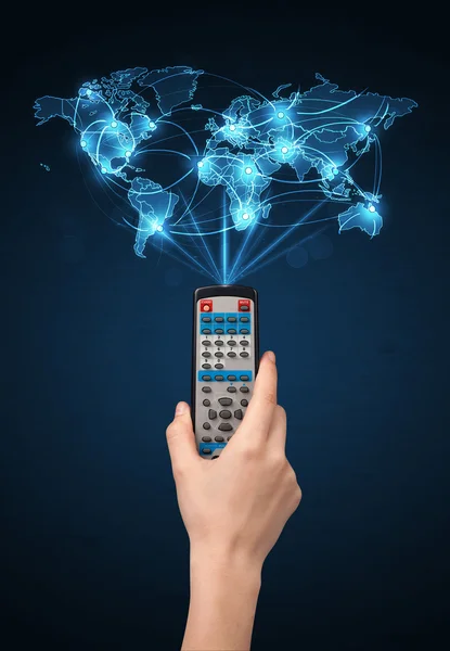 Hand with remote control and social media icons — Stock Photo ...
